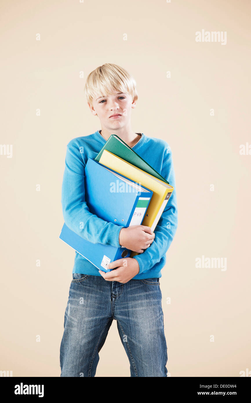 Boy holding folders Stock Photo - Alamy