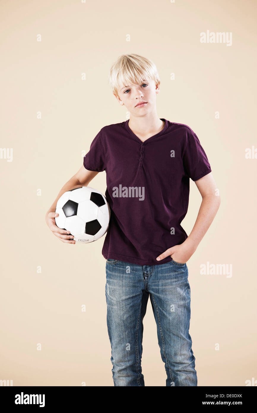 Boy holding a football Stock Photo - Alamy