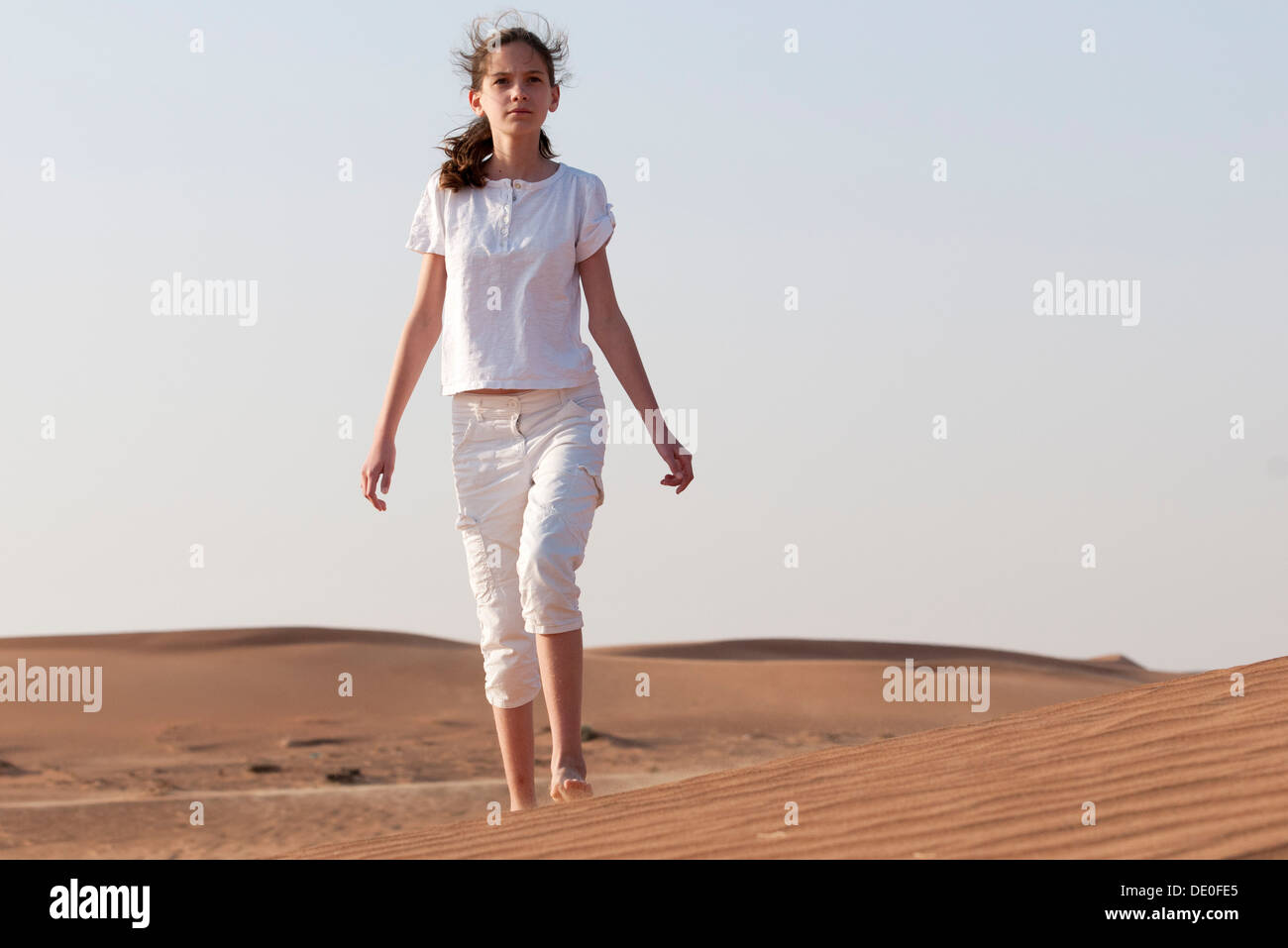 Girl with forlorn expression alone in desert Stock Photo - Alamy