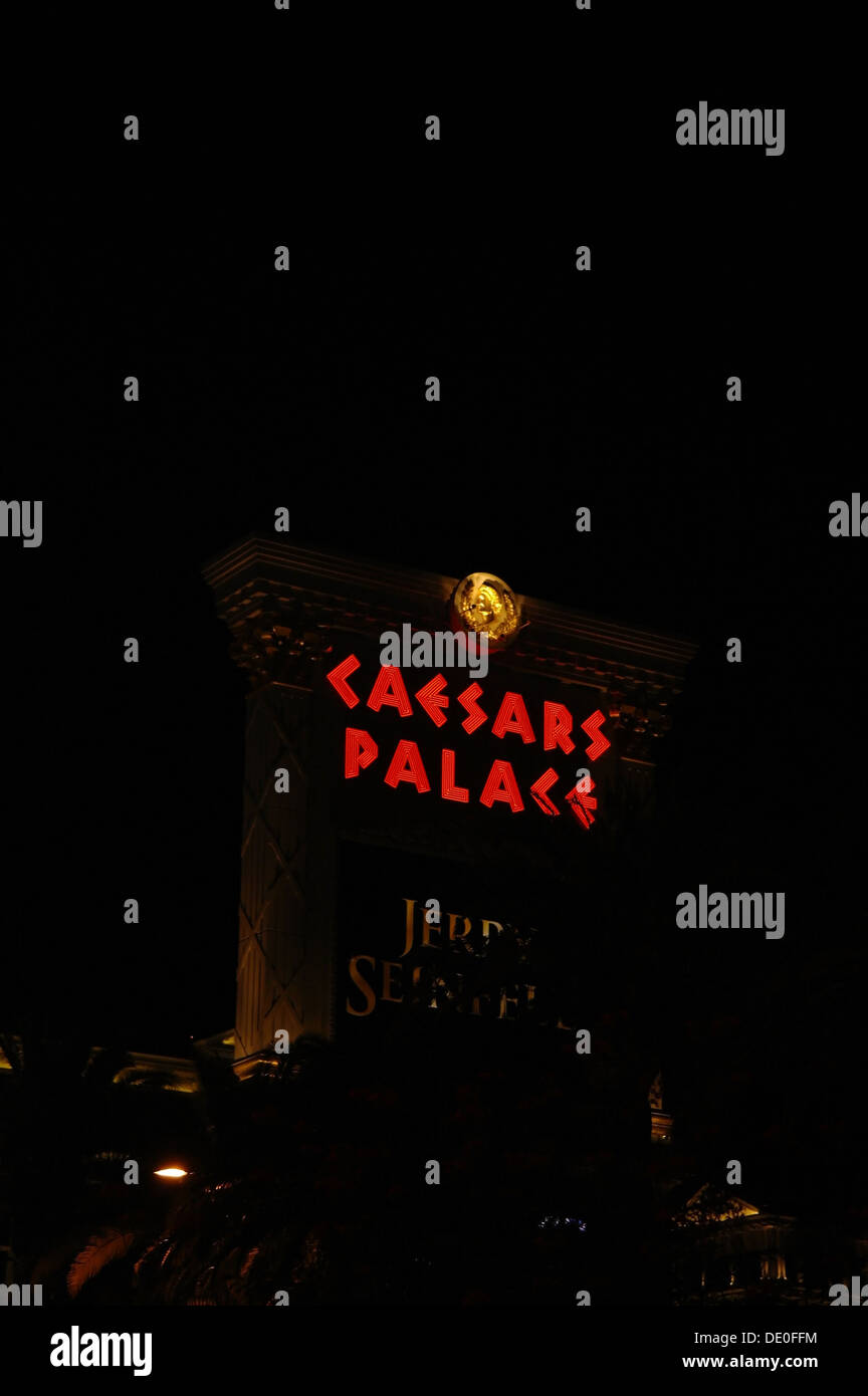 Black sky night portrait illuminated brown masonry red neon name sign ...