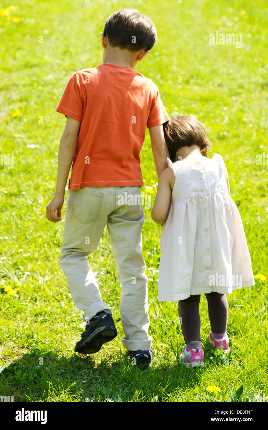 Sister And Older Brother Holding Hands