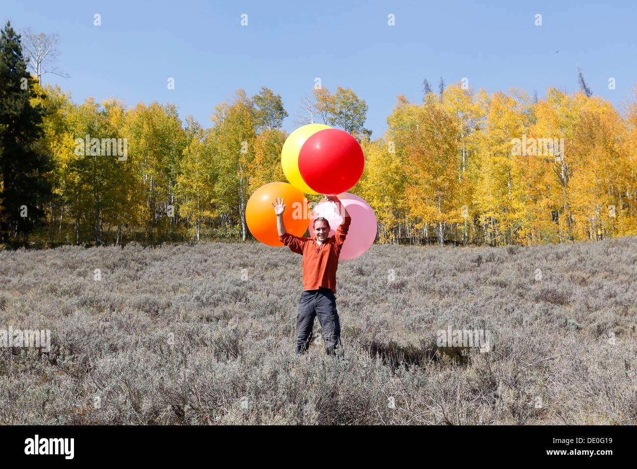 Man carrying balloons hi-res stock photography and images - Alamy
