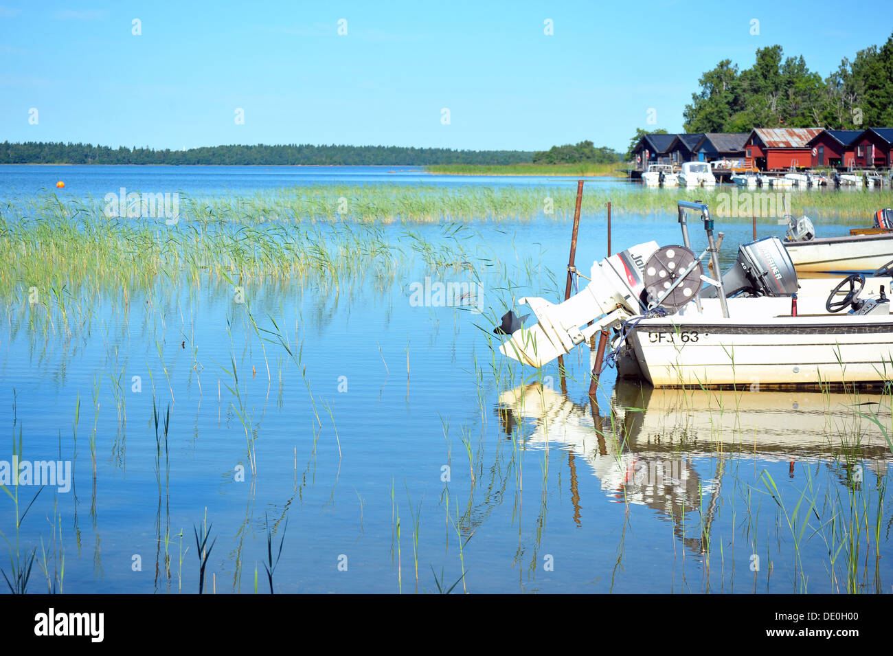 The reflection of the back of a speedboat on calm water Stock Photo - Alamy