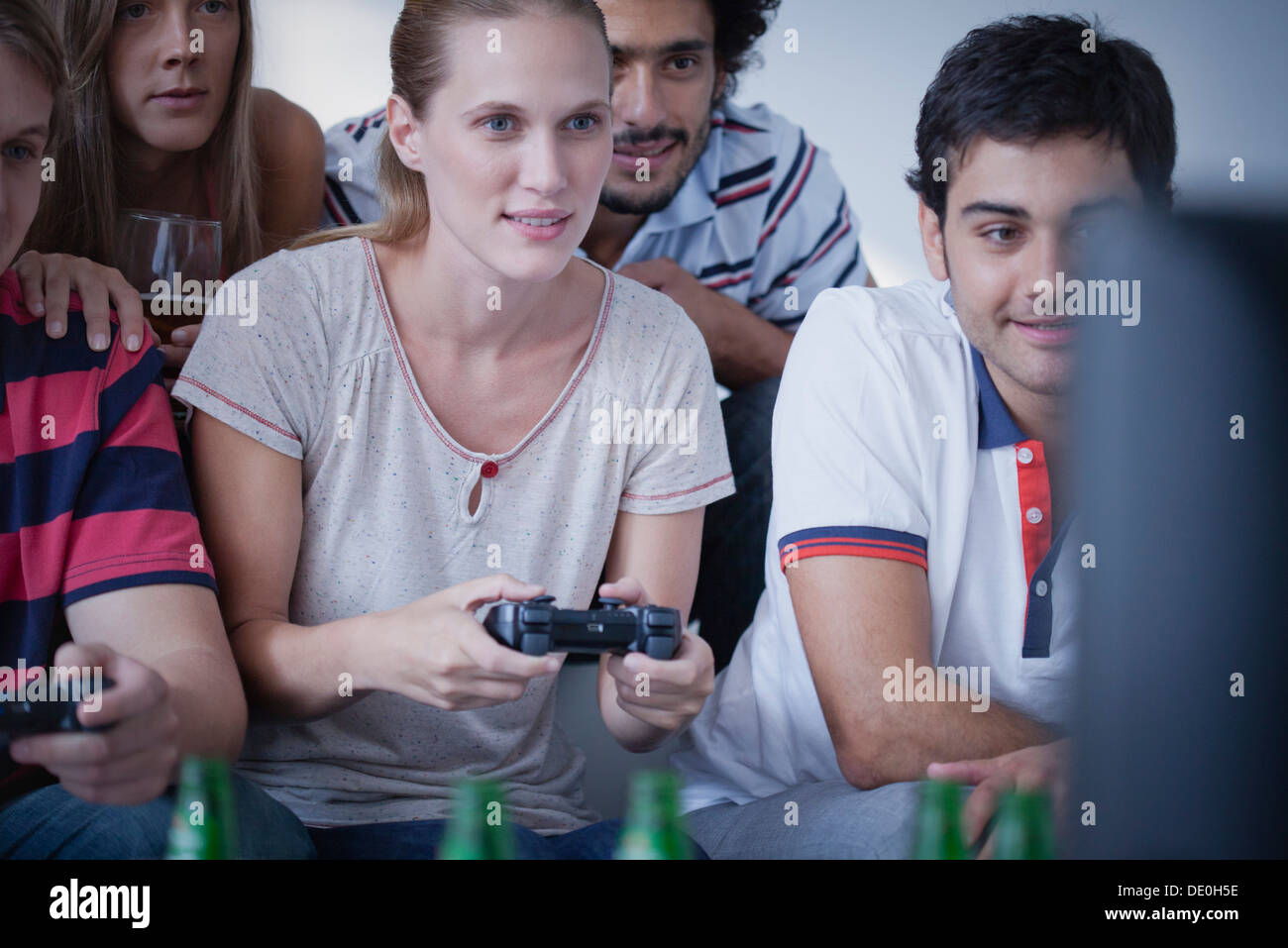 Friends playing video games together Stock Photo - Alamy