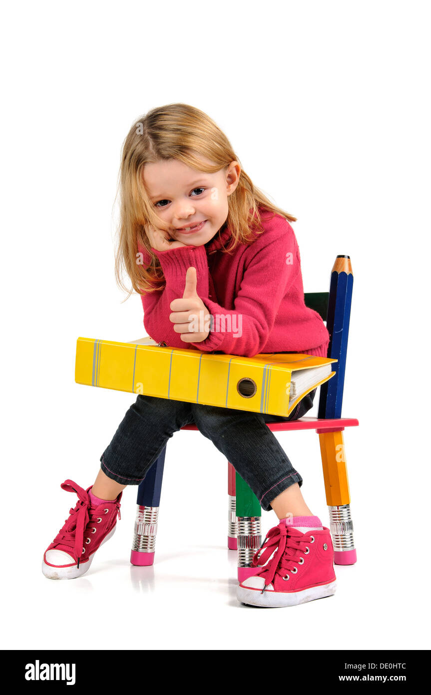 Young girl student seated in a chair isolated in white Stock Photo - Alamy