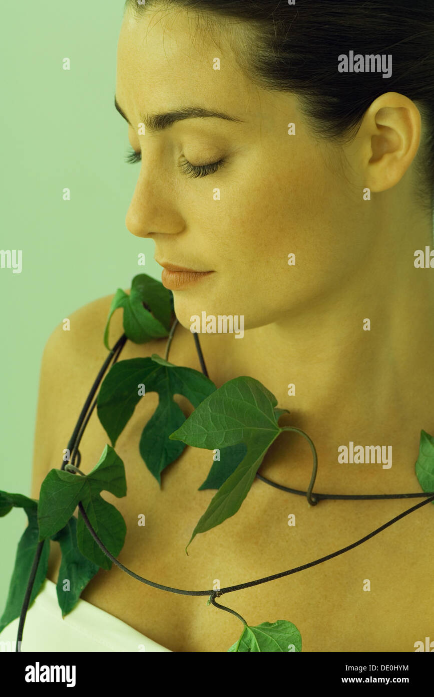 Young woman with leafy vine around neck, close-up Stock Photo - Alamy