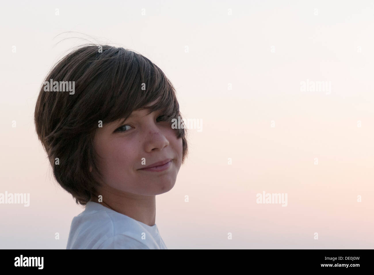 Teenage boy looking over shoulder, portrait Stock Photo - Alamy