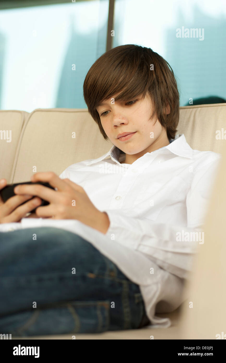 Teenage boy using smartphone Stock Photo - Alamy