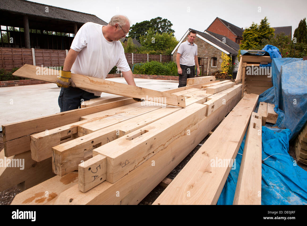self building house, men sorting numbered structural elements of green ...