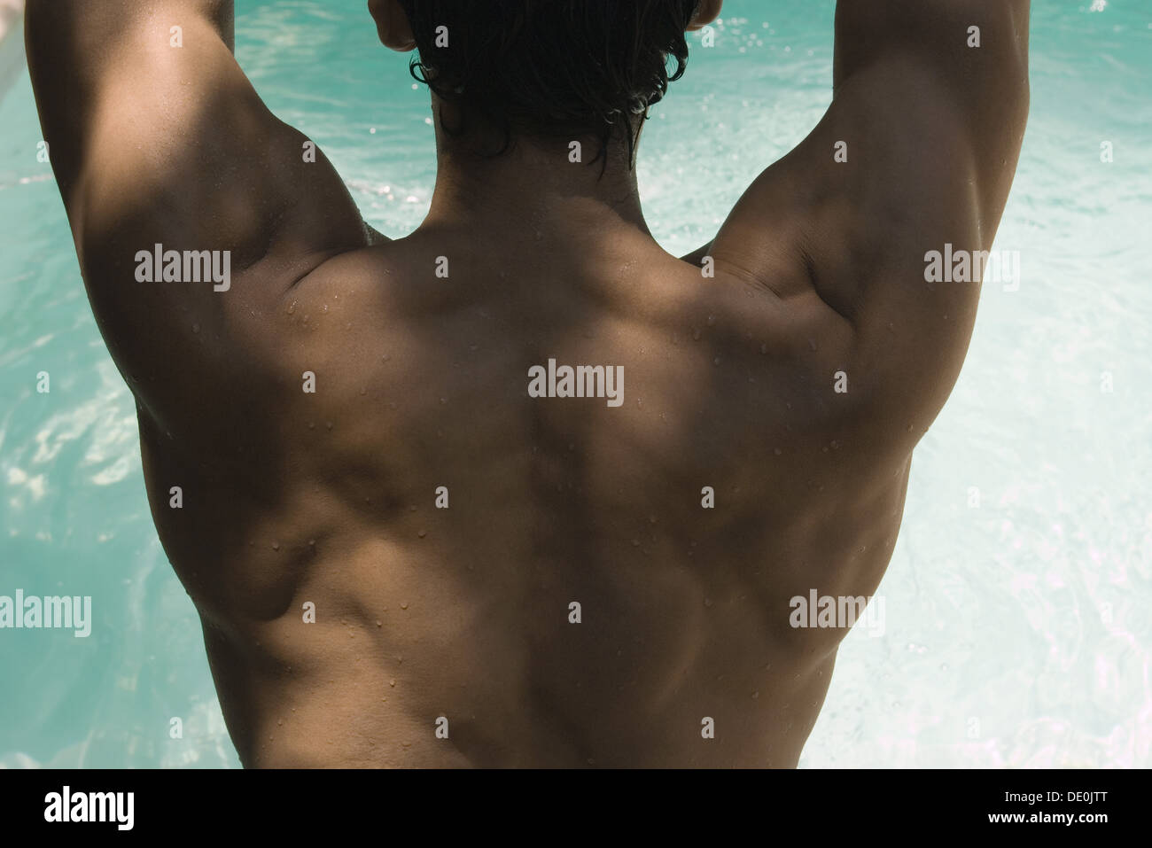 Man's muscular back, water in background Stock Photo - Alamy