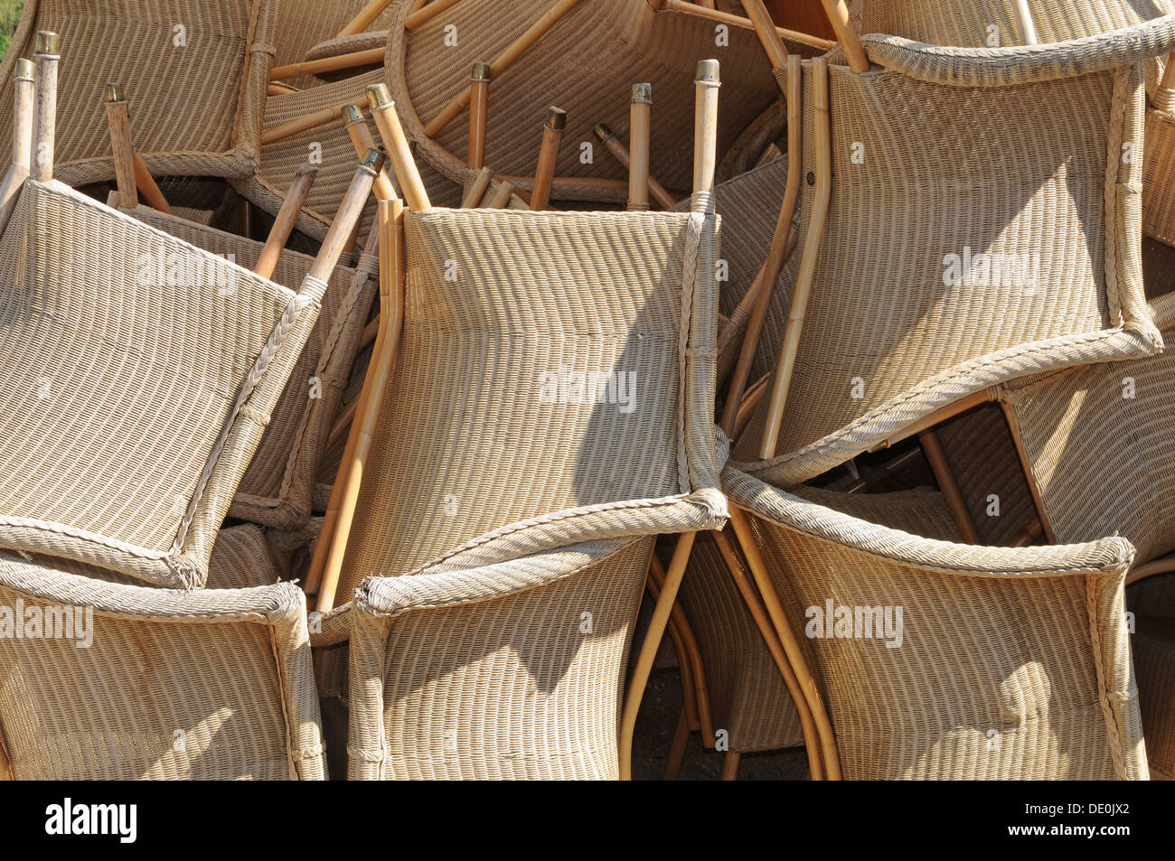 A pile of several wicker chairs Stock Photo - Alamy