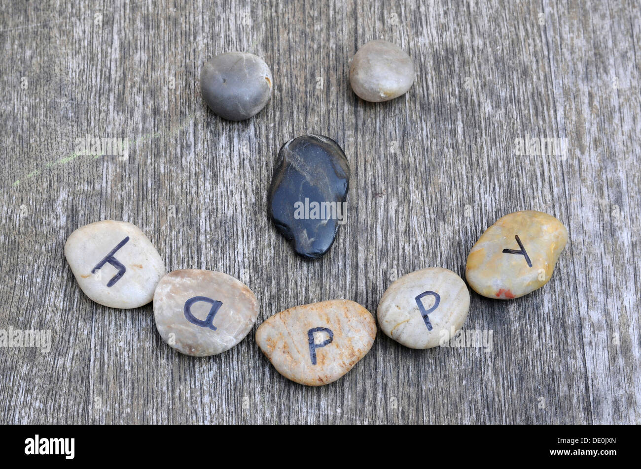 Stones with letters forming a smiley face, lettering "happy Stock Photo ...