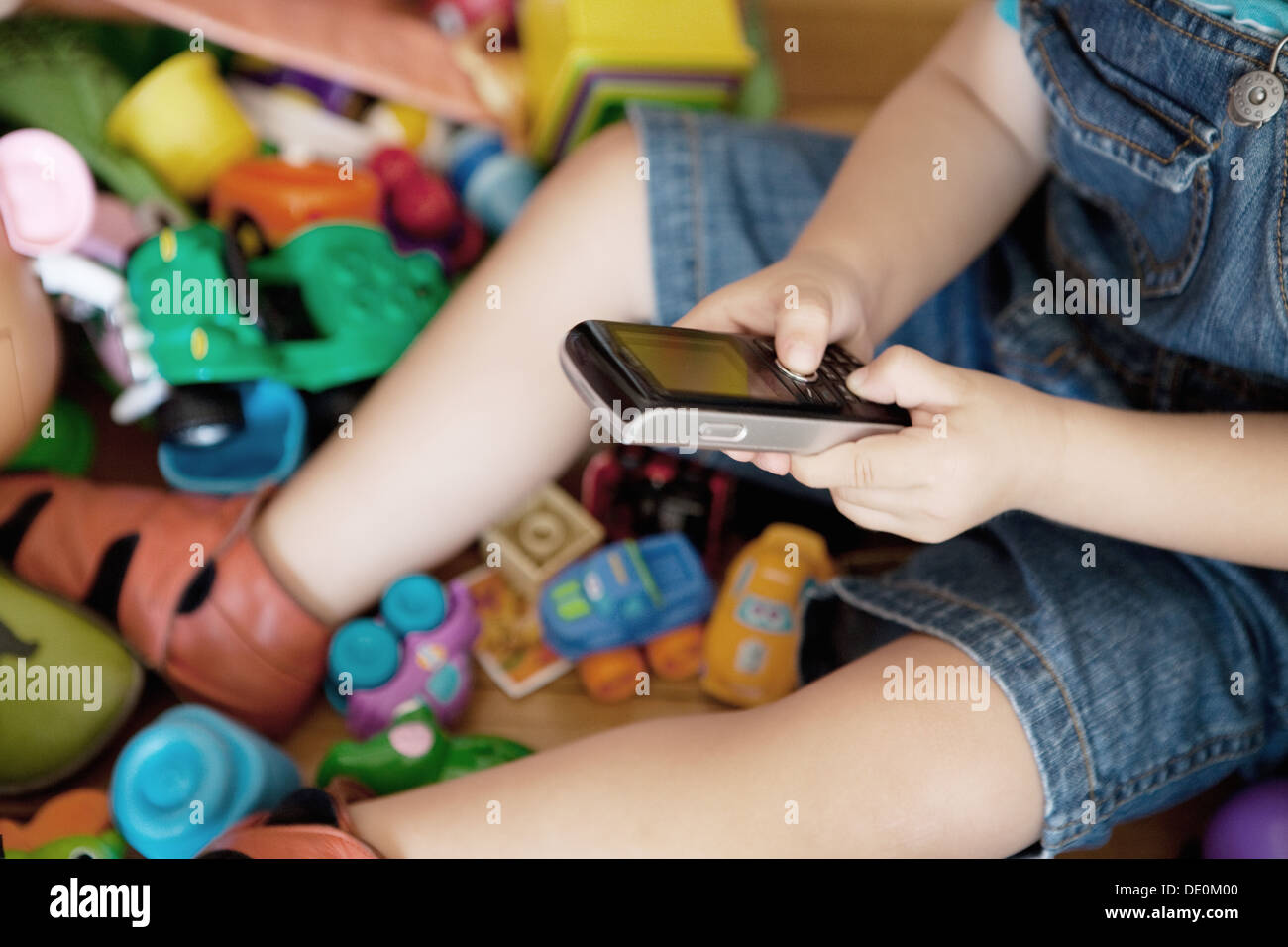 Child playing with cell phone, cropped Stock Photo - Alamy