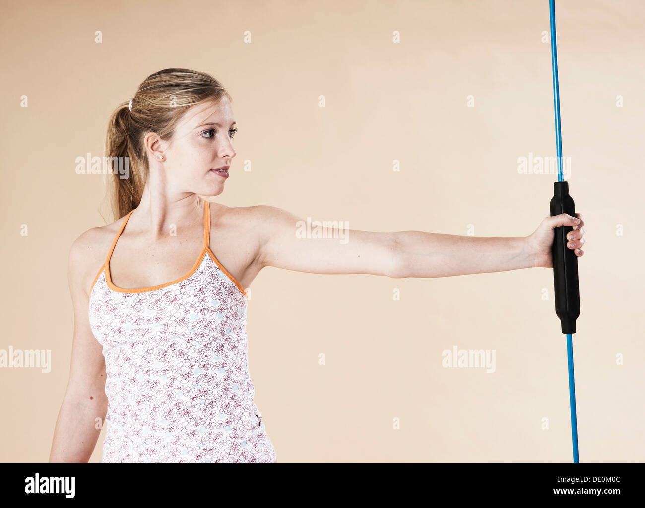 Young woman doing sport exercises with a vibrating rod Stock Photo - Alamy