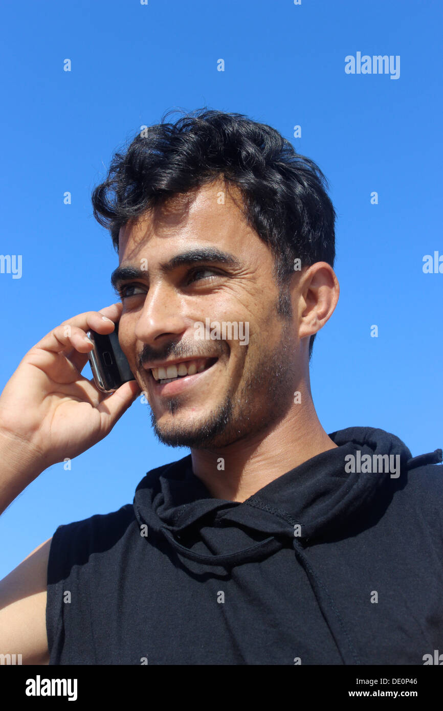 Young man phoning Stock Photo - Alamy