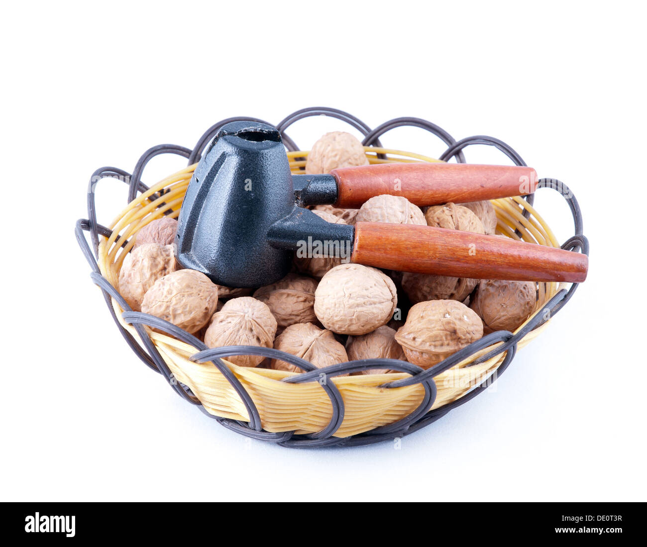 A basket of walnuts and walnut open tools on white background Stock ...