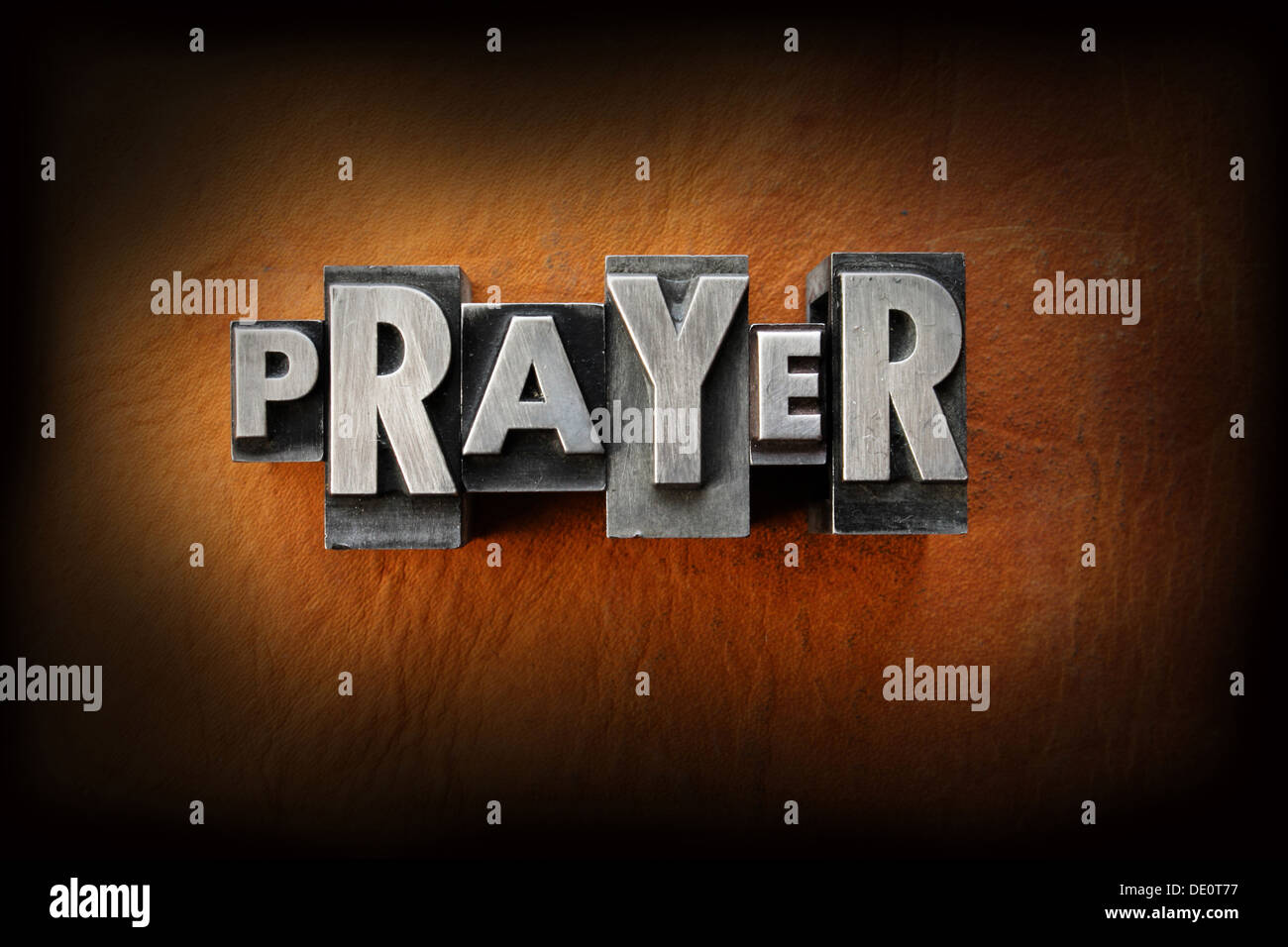 The word prayer made from vintage lead letterpress type on a leather ...