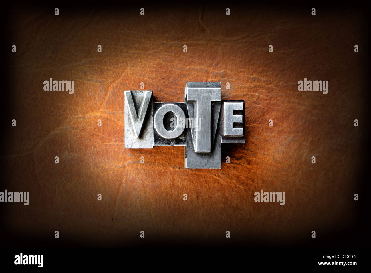 The word vote made from vintage lead letterpress type on a leather ...