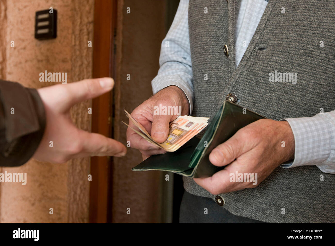 Elderly gentleman falling victim to a fraud, fake grandchild scam Stock ...