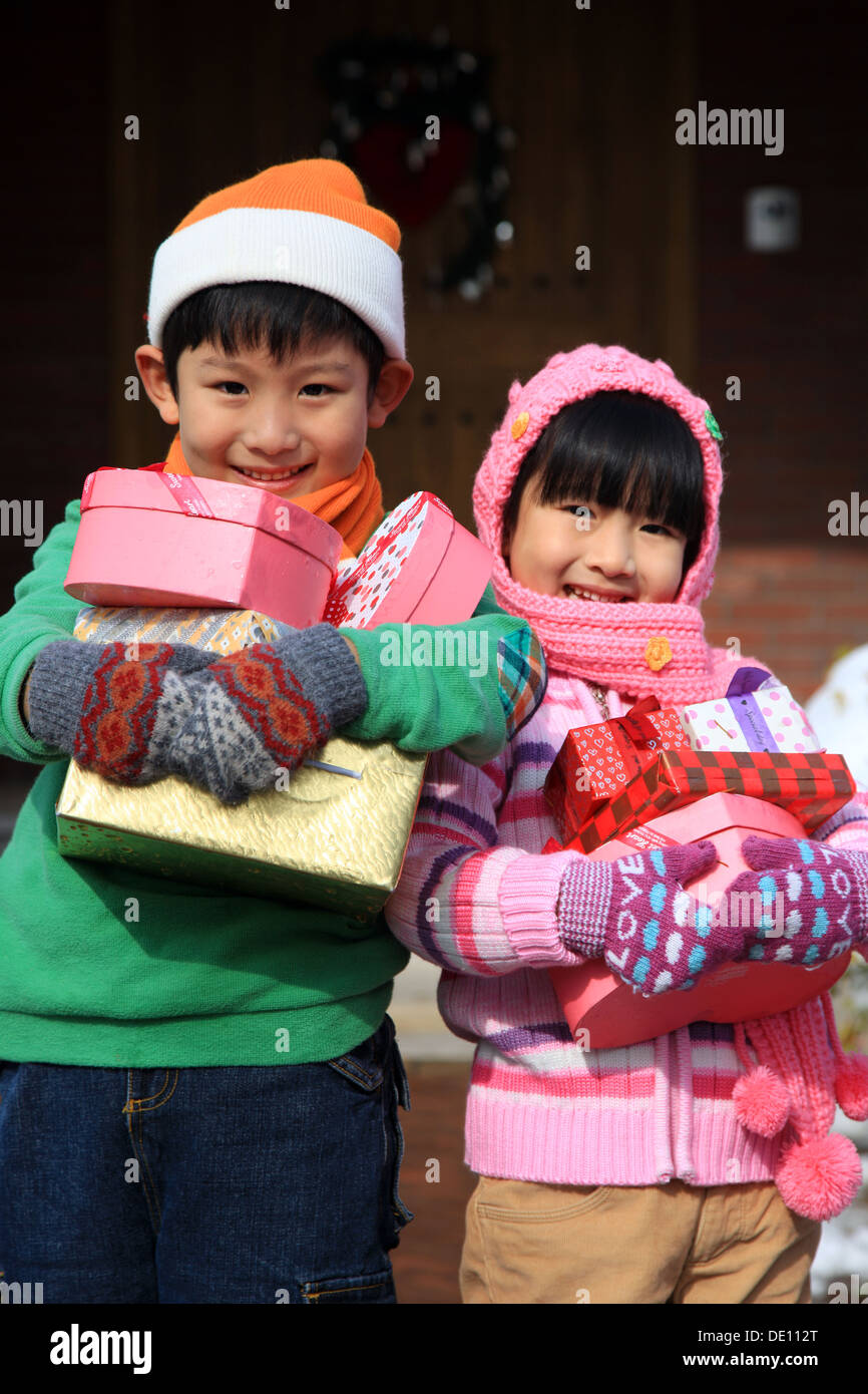 Children holding gift boxes Stock Photo - Alamy