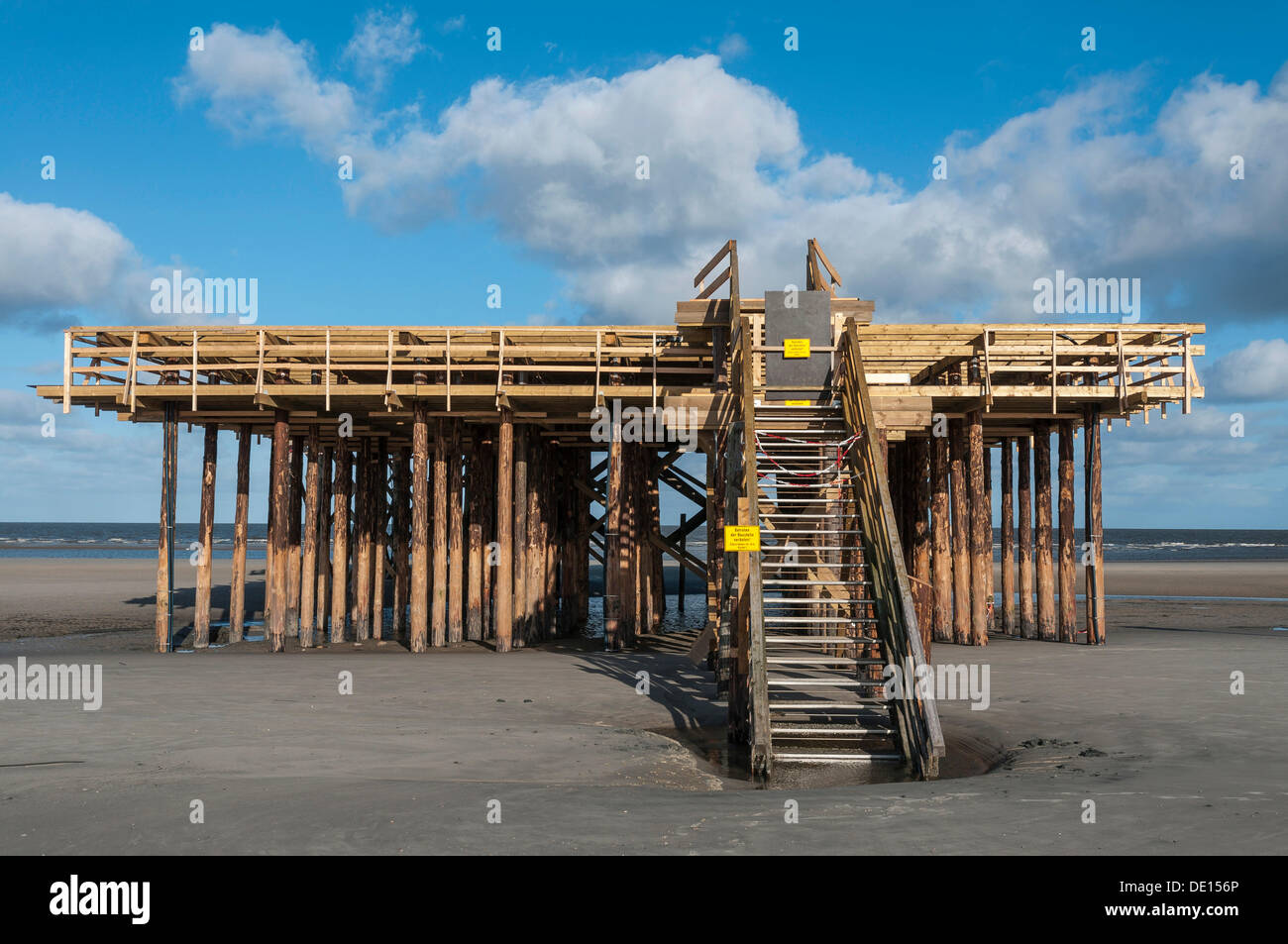 Construction site of a stilt house at low tide on the beach, North Sea ...