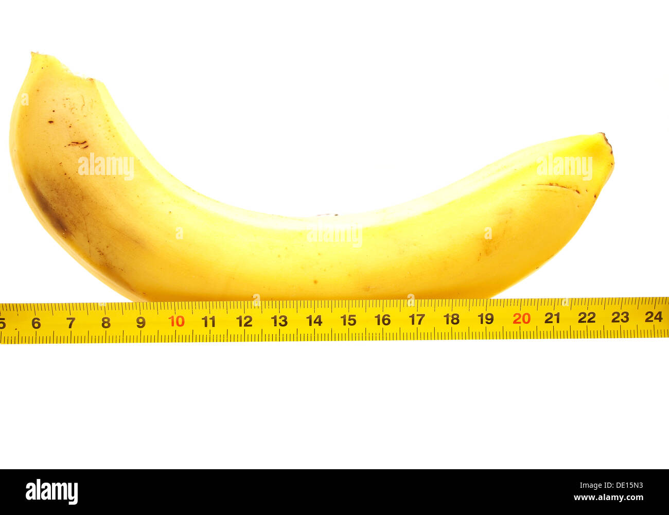 Banana and a ruler on a white background Stock Photo - Alamy