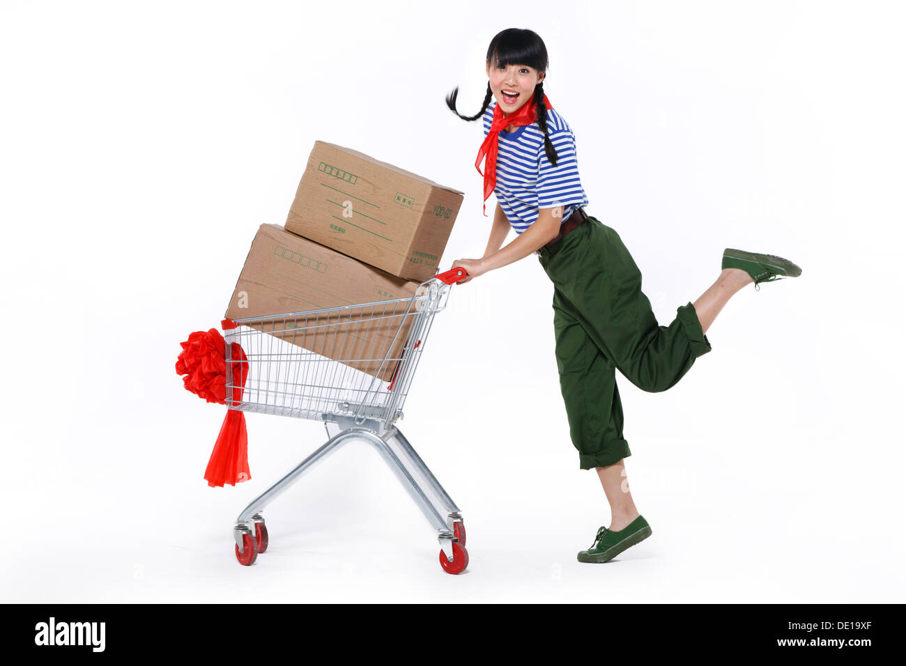Young woman pushing shopping cart Stock Photo - Alamy
