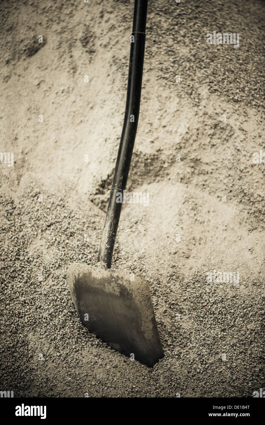 Construction site with closeup of spade stuck in a pile of sand Stock ...
