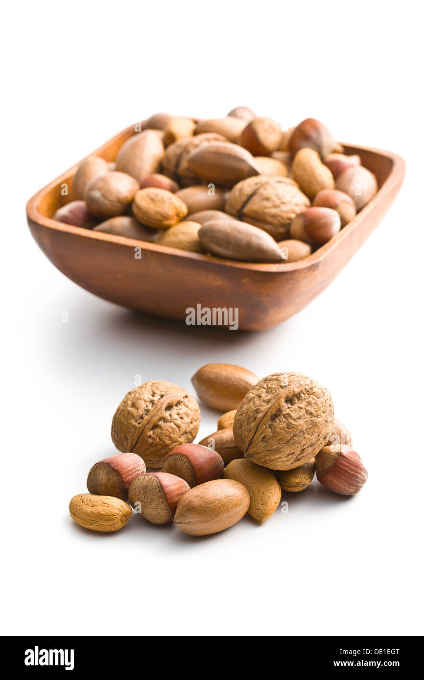 various unpeeled nuts in wooden bowl on white background Stock Photo ...