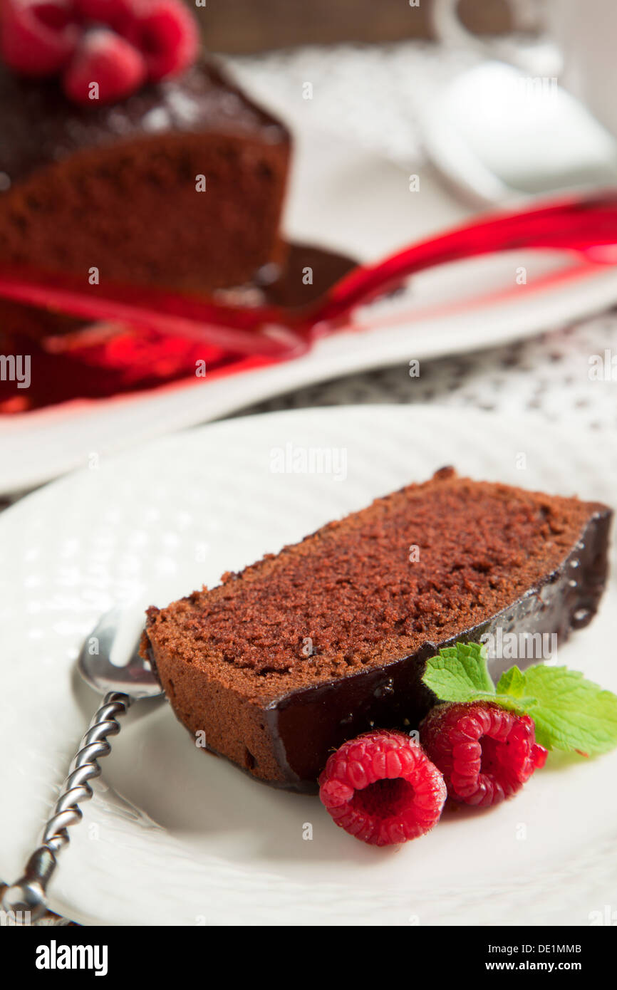 Chocolate loaf cake with chocolate frosting and raspberry Stock Photo ...