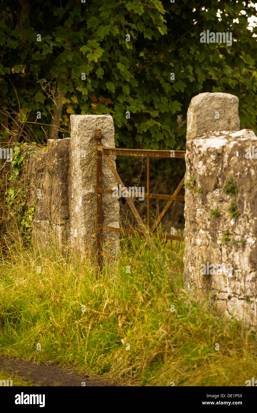 Rusted iron Gate between two granite pillars Stock Photo - Alamy