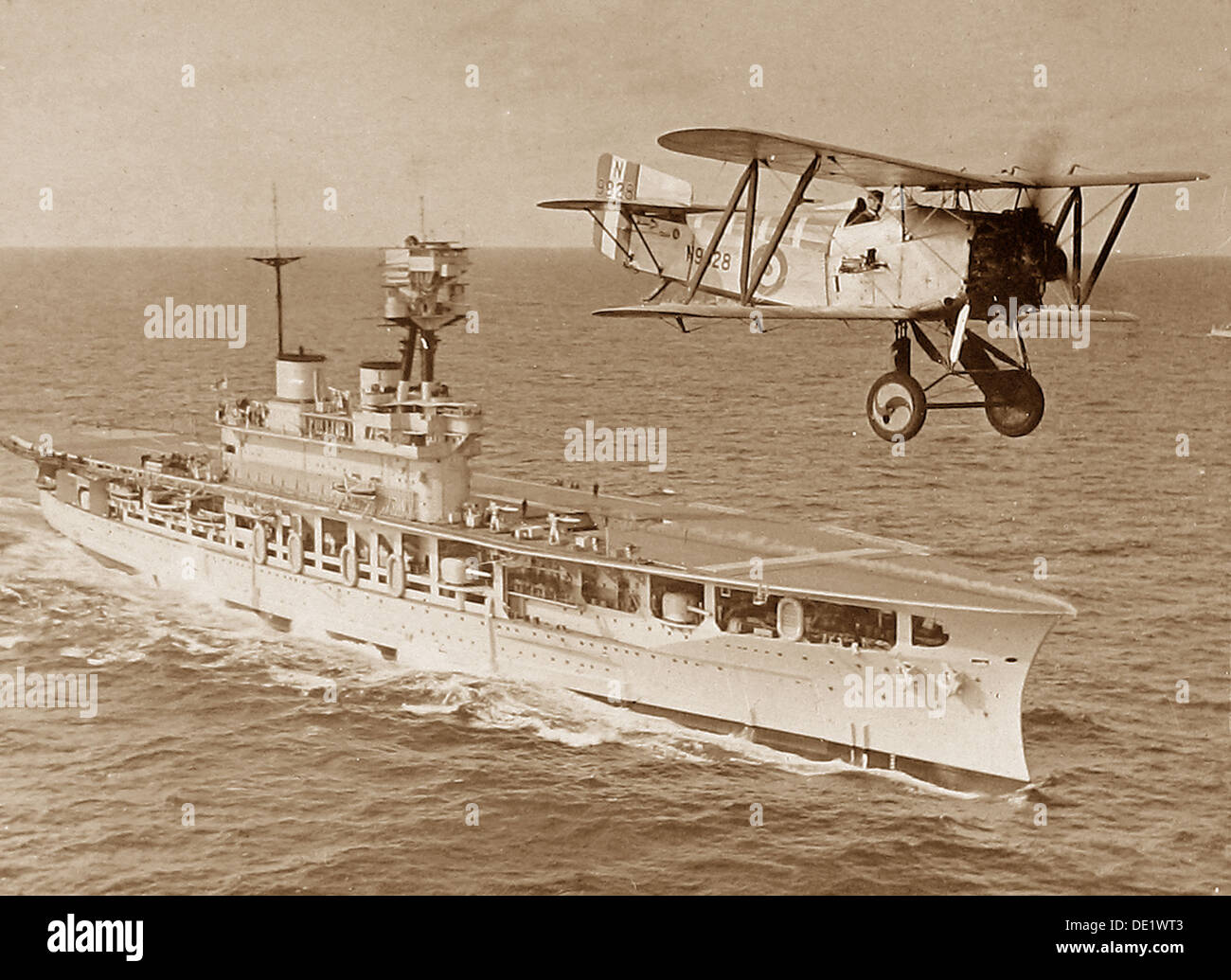 Biplane just taken off from an aircraft carrier early 1900s Stock Photo ...