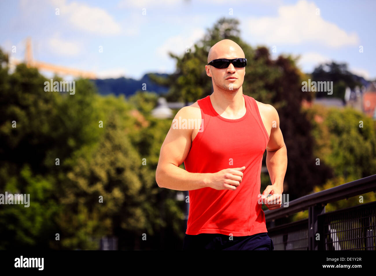 A young man jogging in the city Stock Photo - Alamy