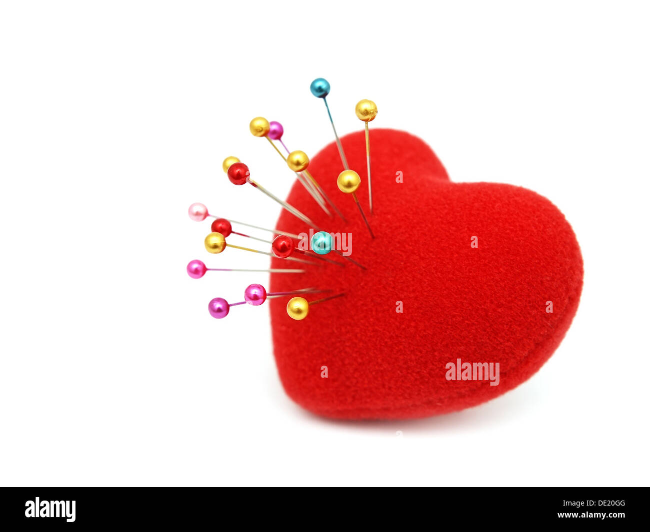 Red heart stabbed by pins on white background Stock Photo - Alamy