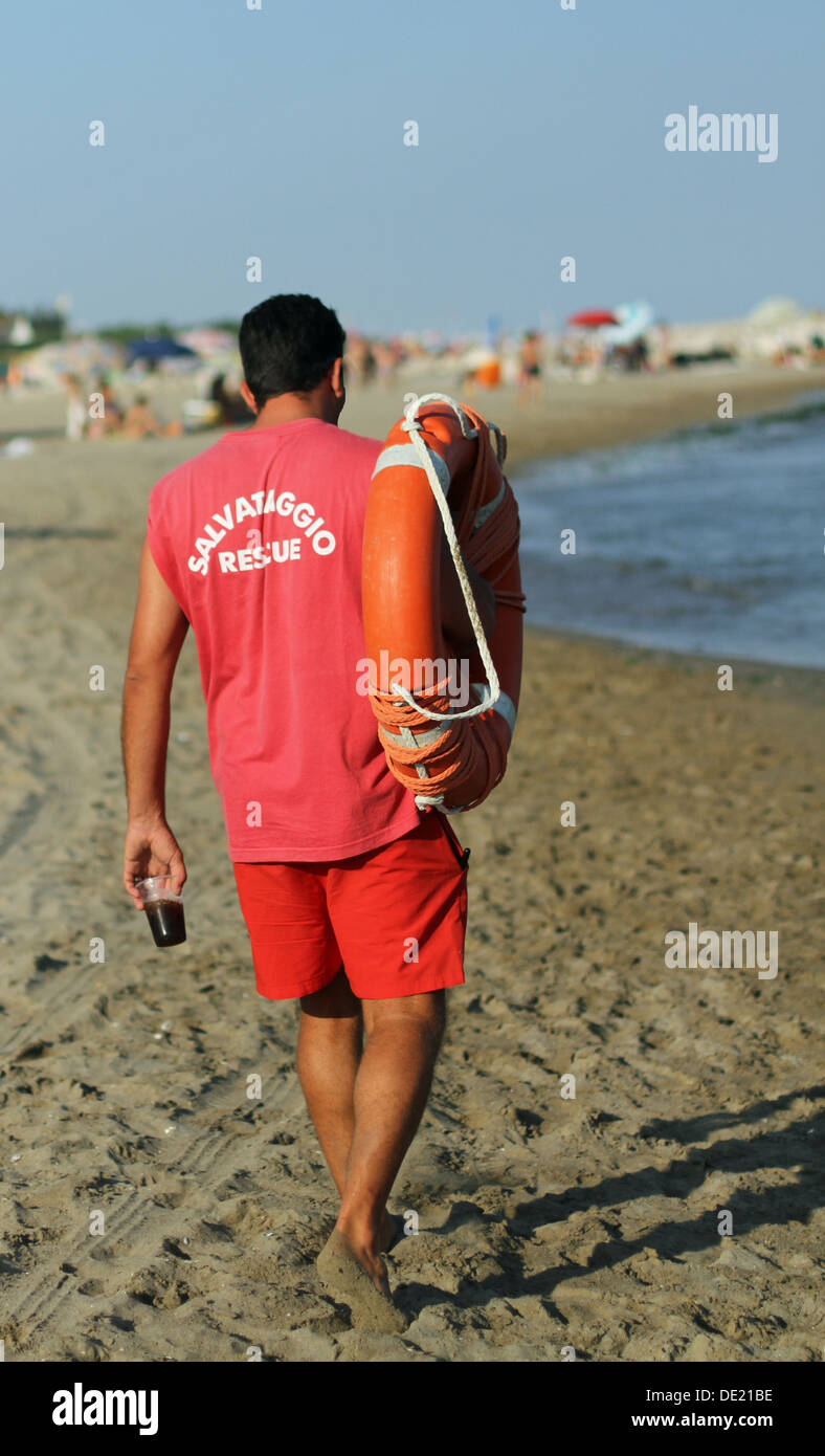 Lifeguard on the beach with a glass of soda and lifesaver Stock Photo ...