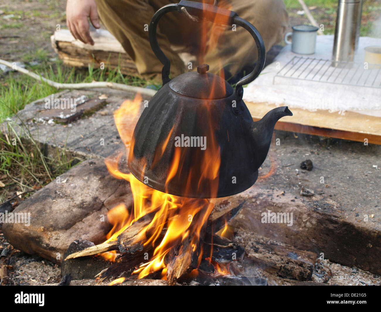 Teapot and kettle on a fire in the summer Stock Photo - Alamy