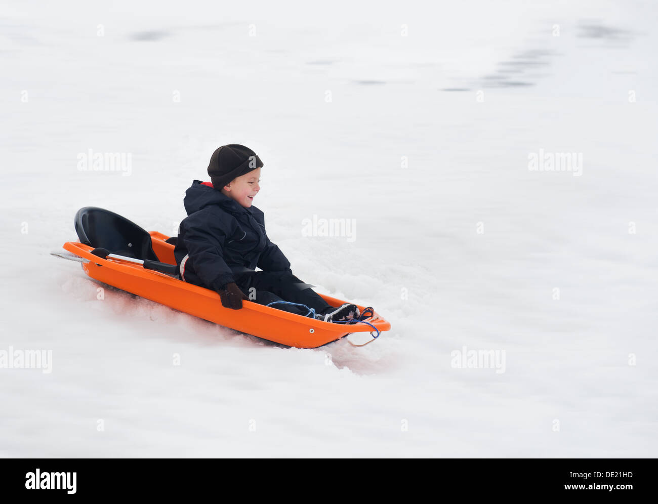 boy rides a sled winter Stock Photo - Alamy