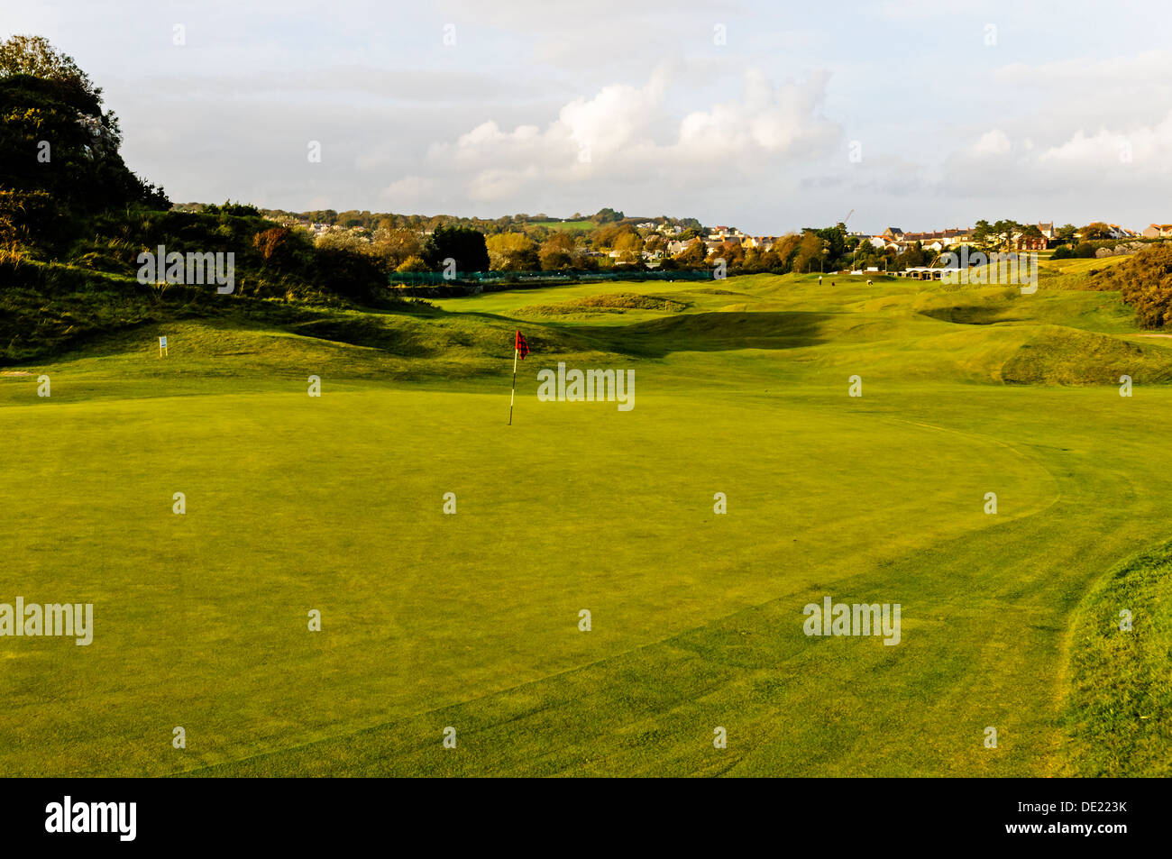 Two golfers play the tricky fairway and contoured green of a classical ...