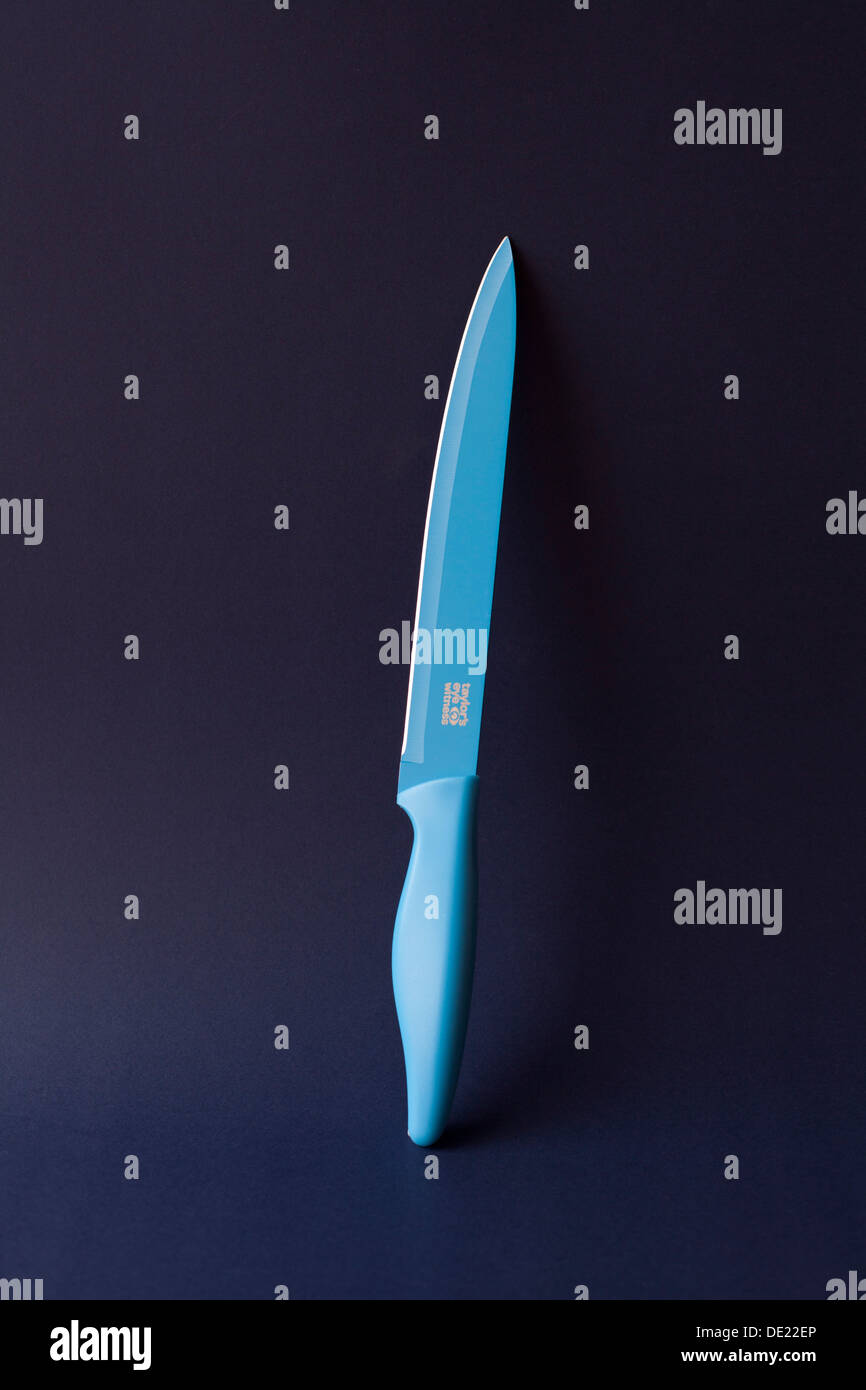 Blue fillet knife on a blue background Stock Photo - Alamy