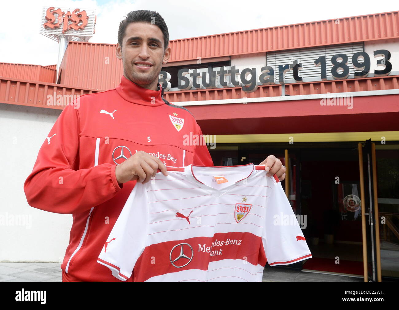 The Tunisian national soccer player, Karim Haggui, presents a jersey of ...
