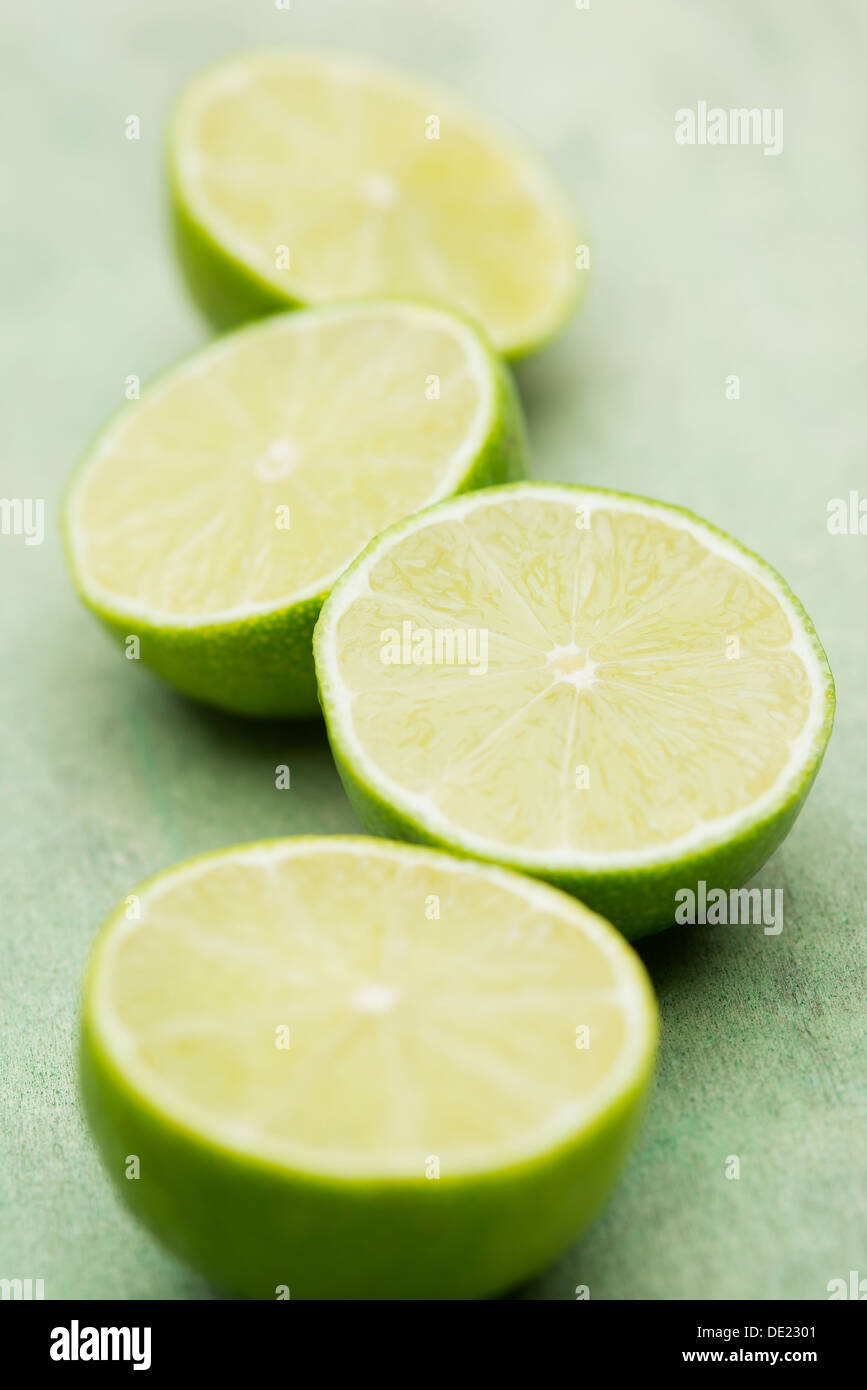 A still life arrangement of fresh juicy green limes cut in half Stock ...