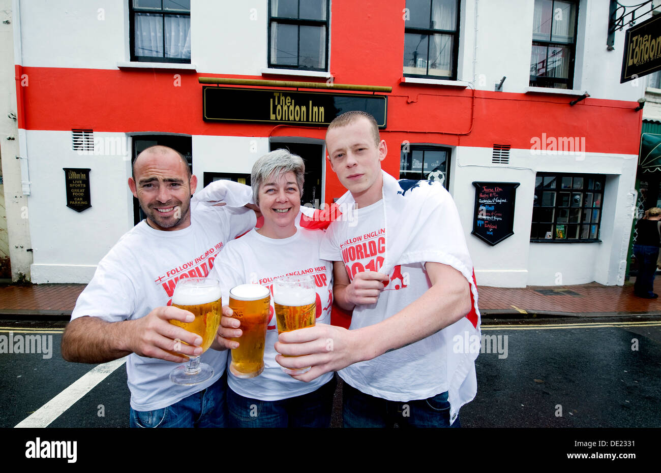 Football mad bar staff outside the London Inn, Braunton in Devon UK ...