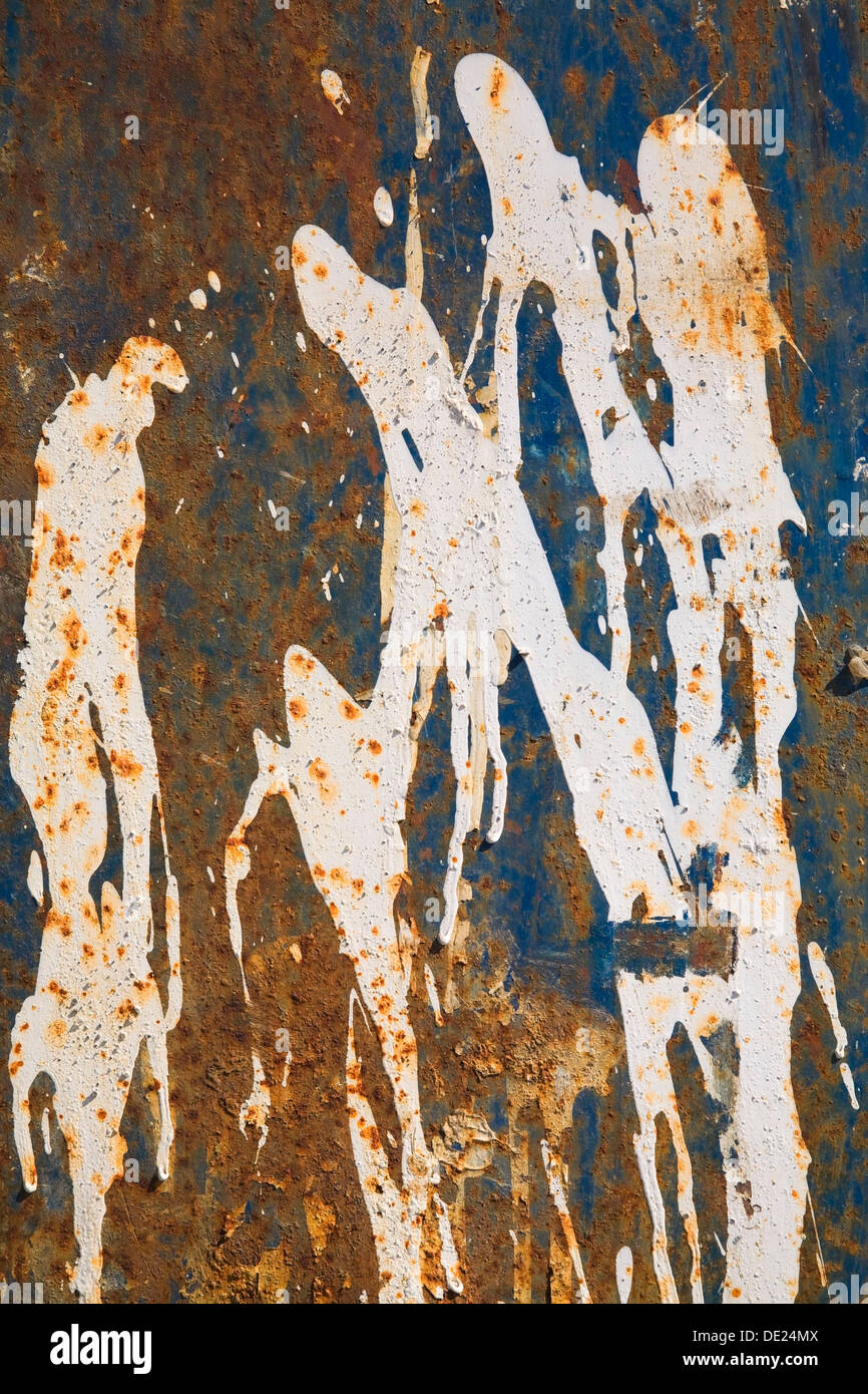 Rust and white paint patterns on a ferrous metal surface, Laval, Quebec ...