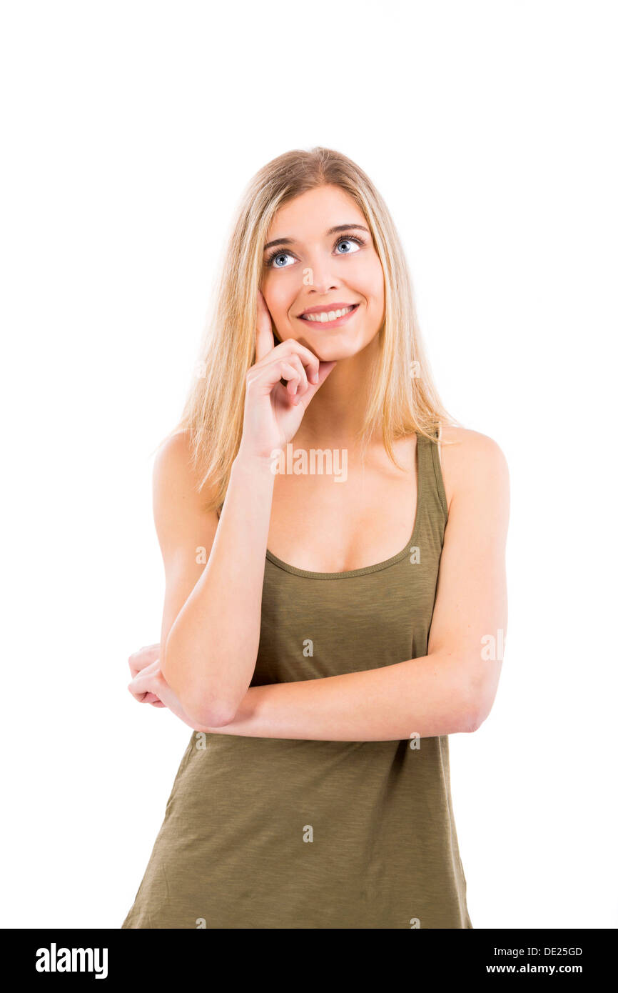 Beautiful blond woman smiling and thinking on something to the camera ...