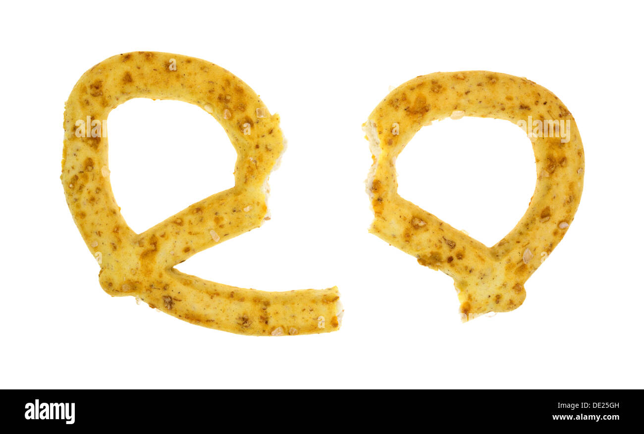 A single honey and oat flavored pretzel broken on a white background ...