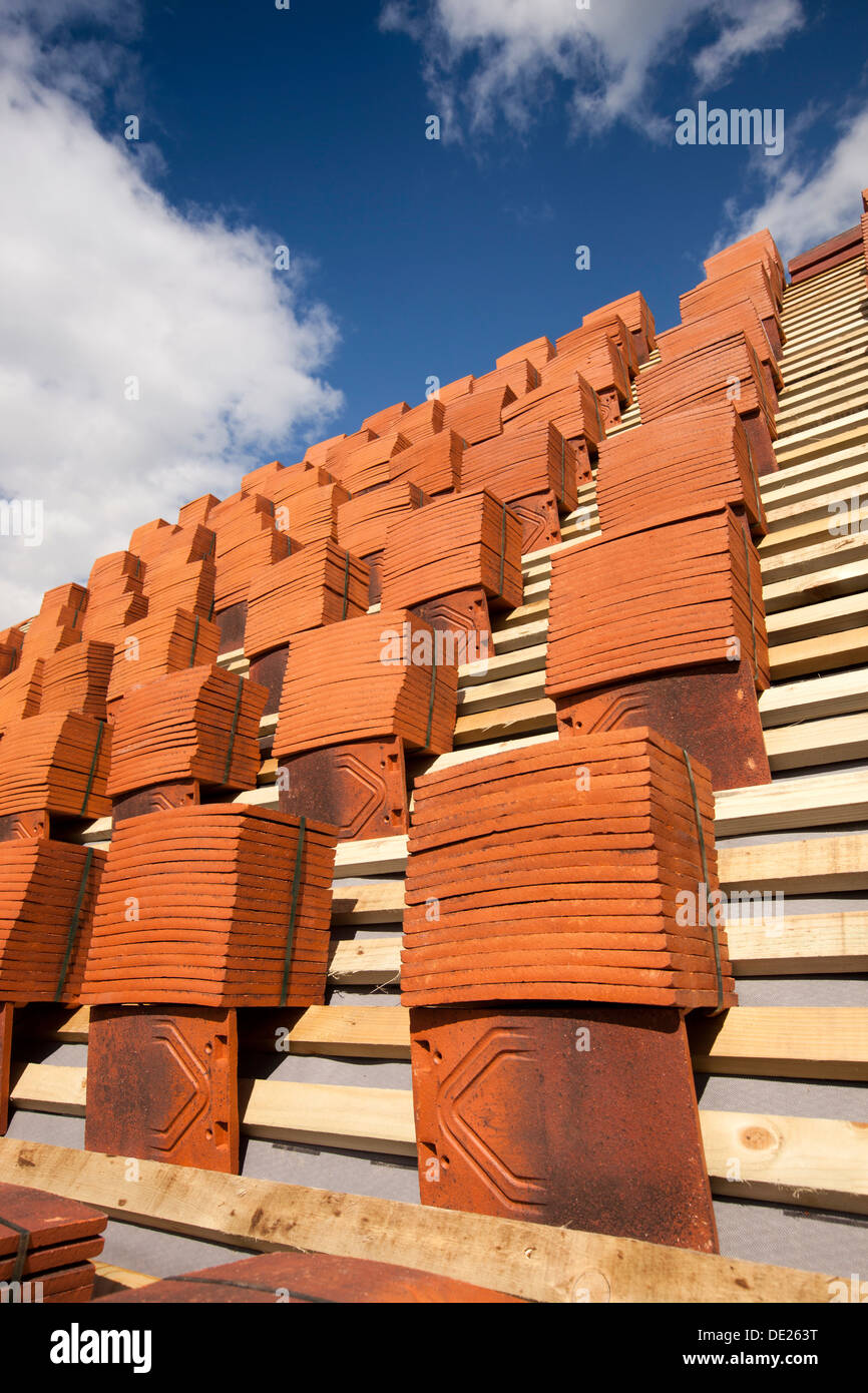 self building house, roofing, piles of traditional clay roof tiles ...