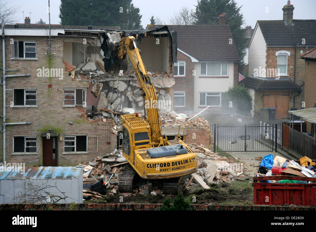 The Demolition of a Small block of Flats using an excavator Stock Photo ...