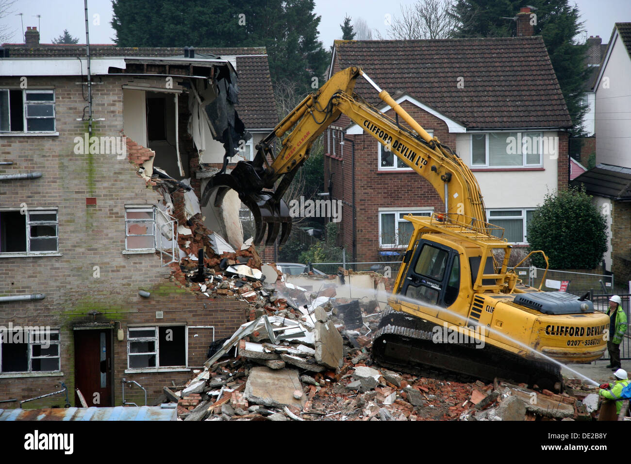 The Demolition of a Small block of Flats using an excavator with a man ...