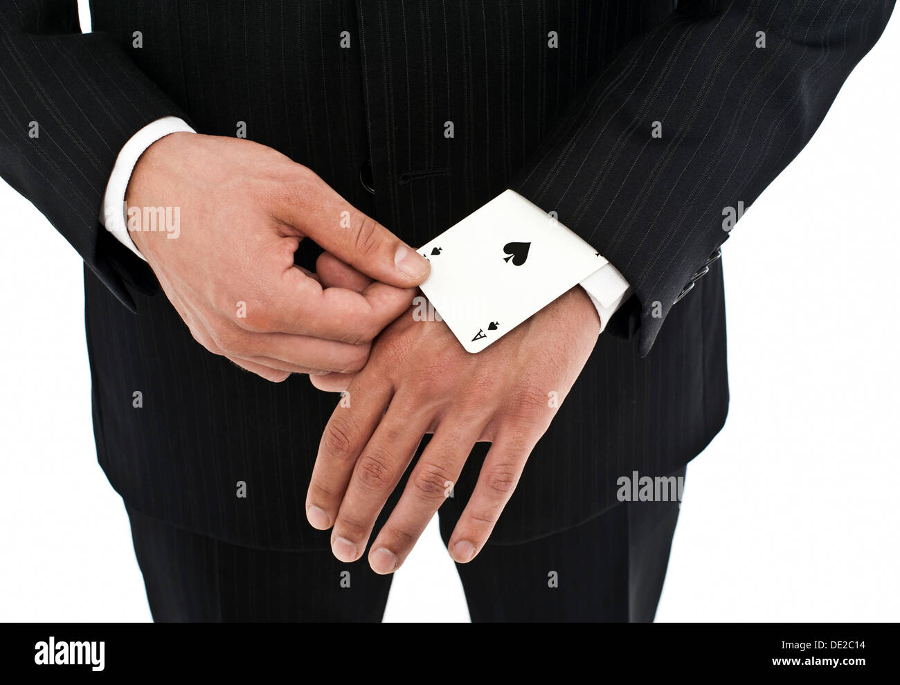 Man wearing a suit pulling an ace of spades out of his sleeve Stock ...