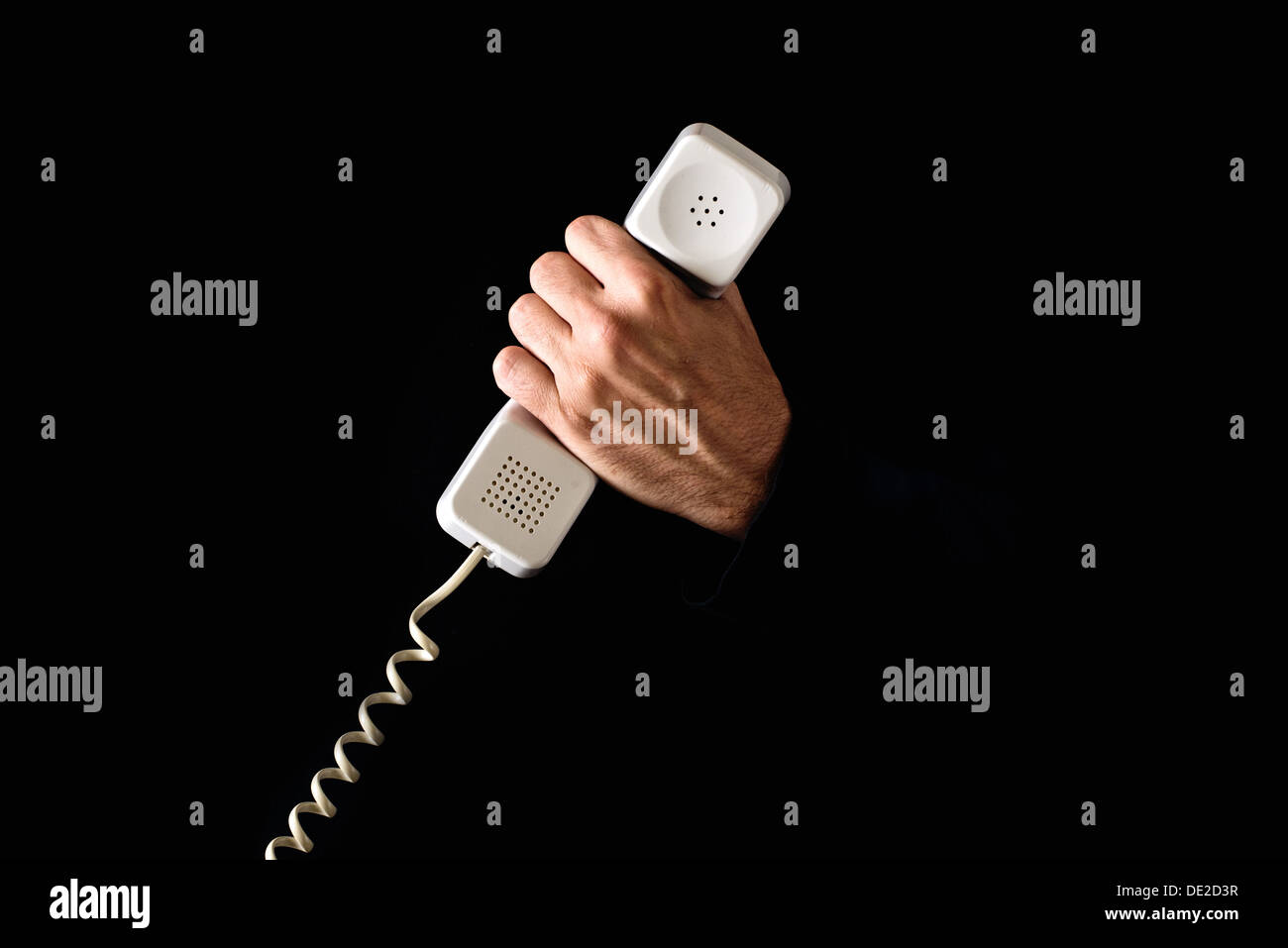 Hand holding white telephone receiver on dark background Stock Photo ...